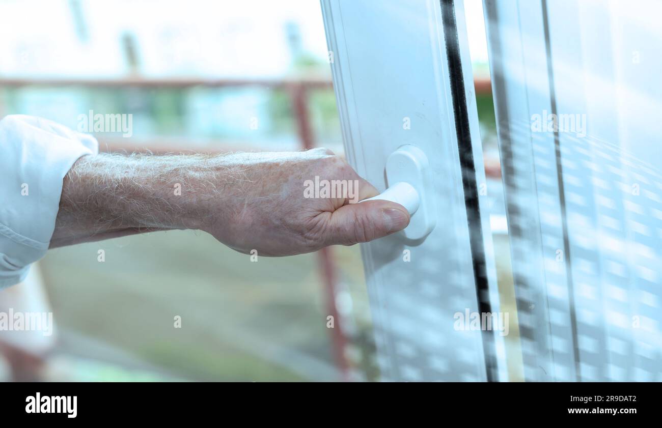 Male hand opening a window; light effect Stock Photo - Alamy