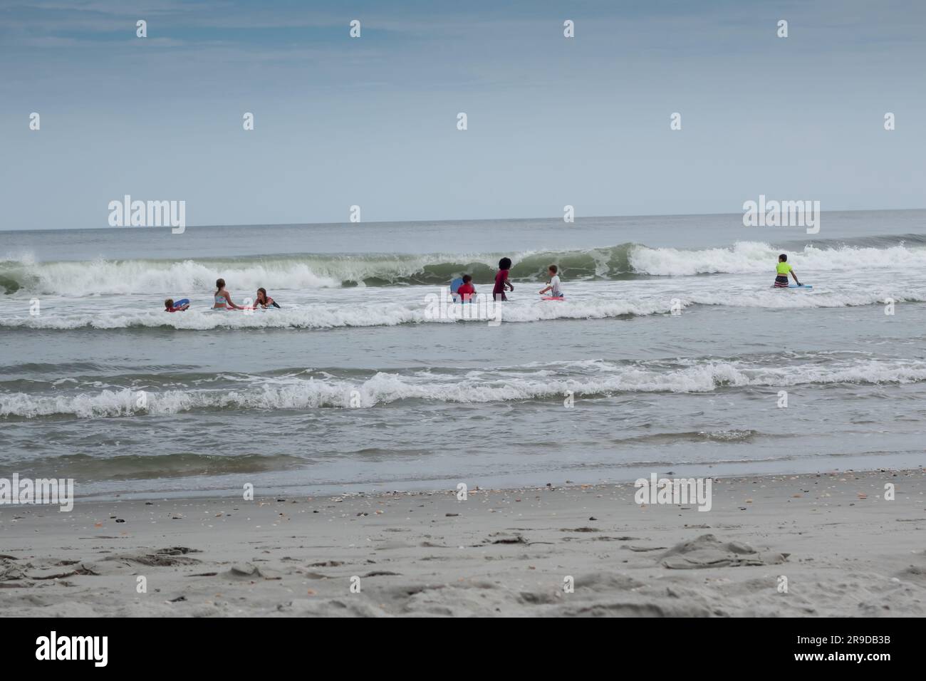 A group of people enjoying their time in shallow waters of the sea ...