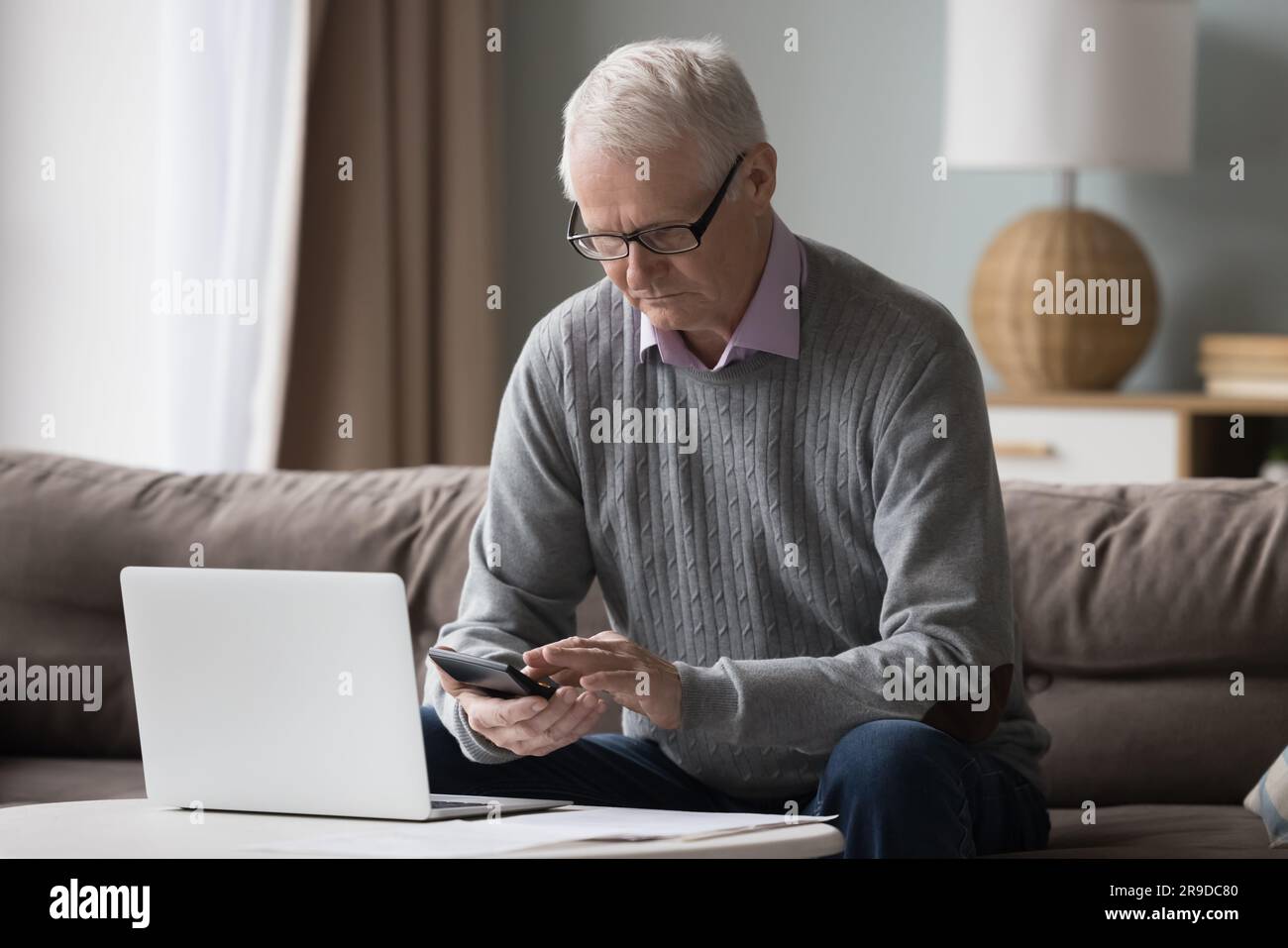 Serious Middle Aged Man Calculate Monthly Payments Stock Photo Alamy