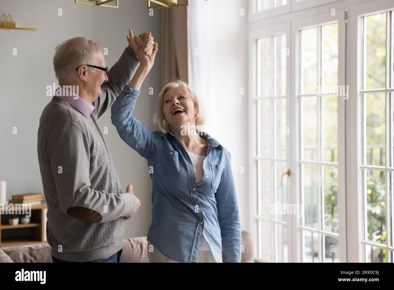 Carefree couple of older retirees dancing at home Stock Photo - Alamy