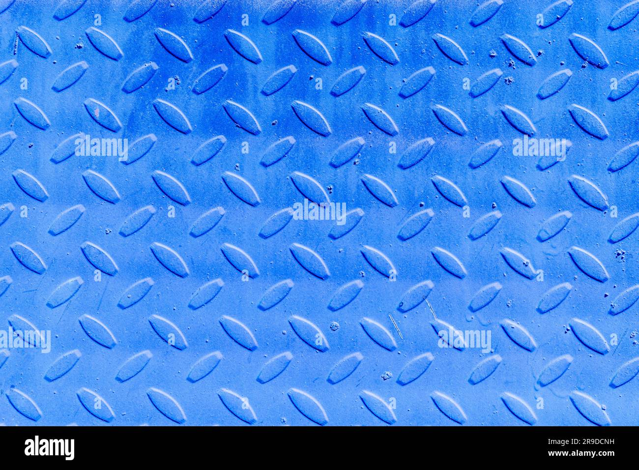 The background of the corrugated iron sheet is blue. Textured abstract ...
