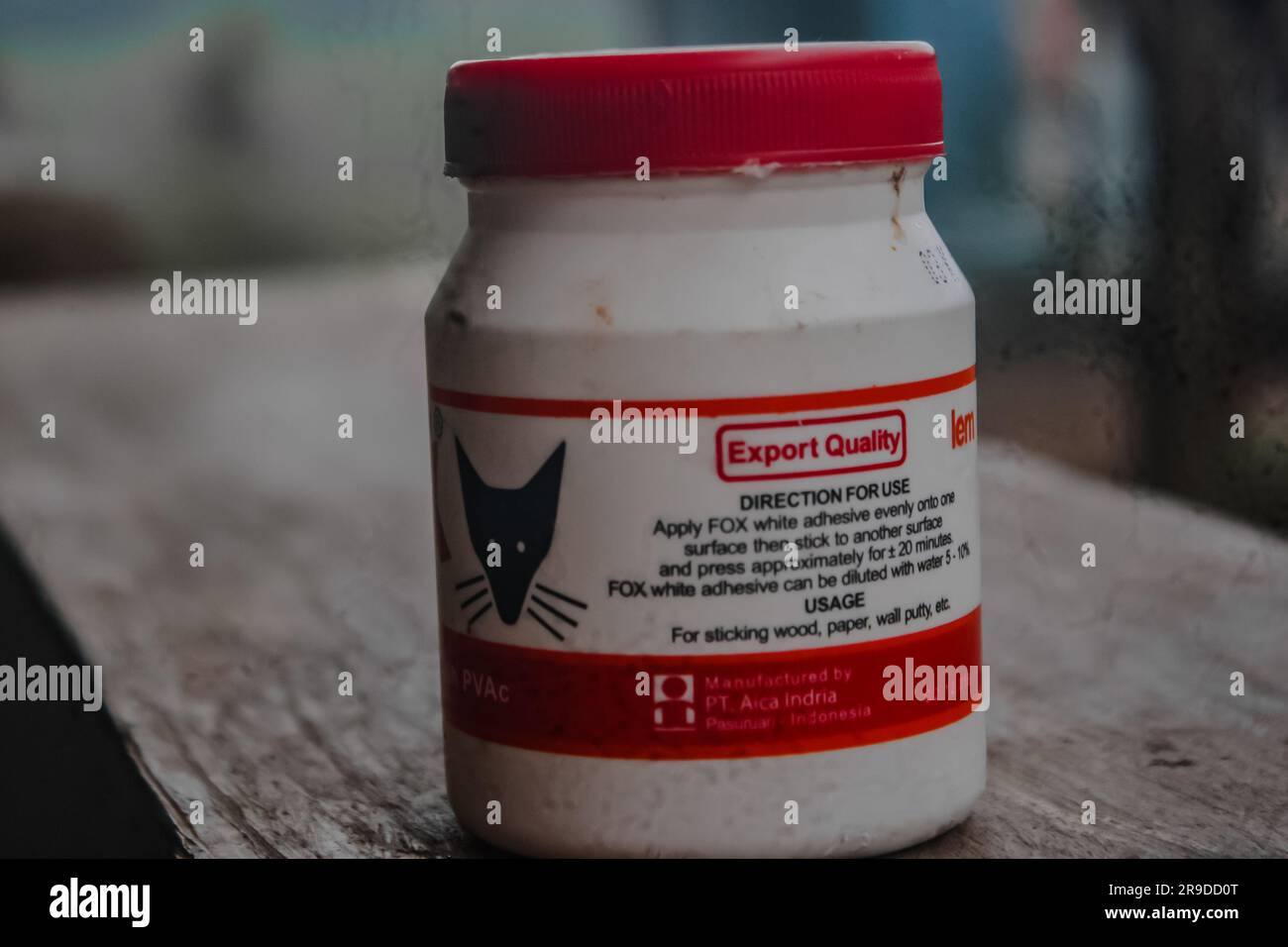 A wood glue with a white jar and a red lid that is suitable for use on ...