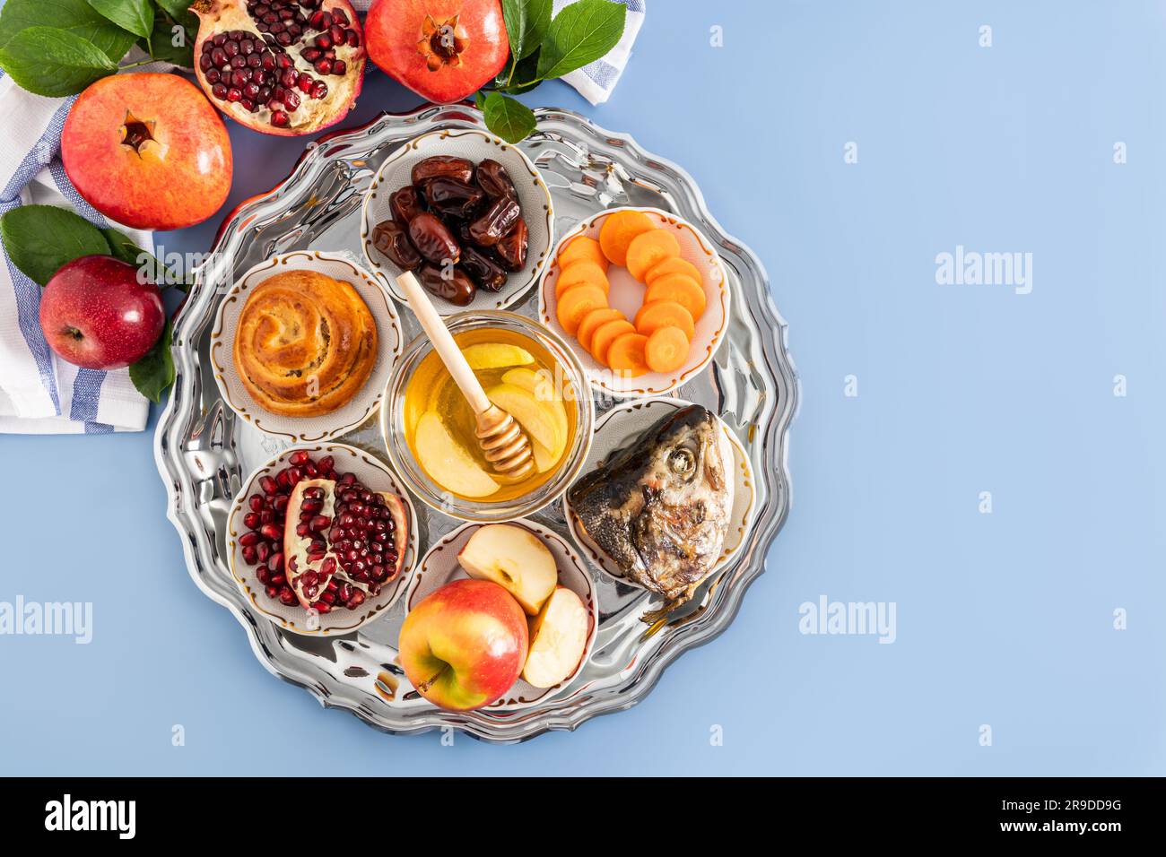 A silver plate with traditional treats for the Jewish New Year. The ...