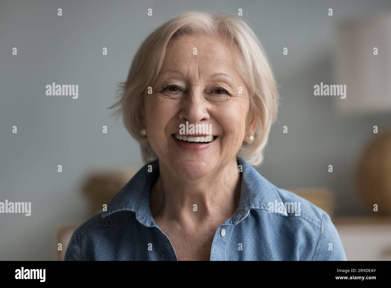 Head shot portrait happy retired woman staring at camera Stock Photo ...