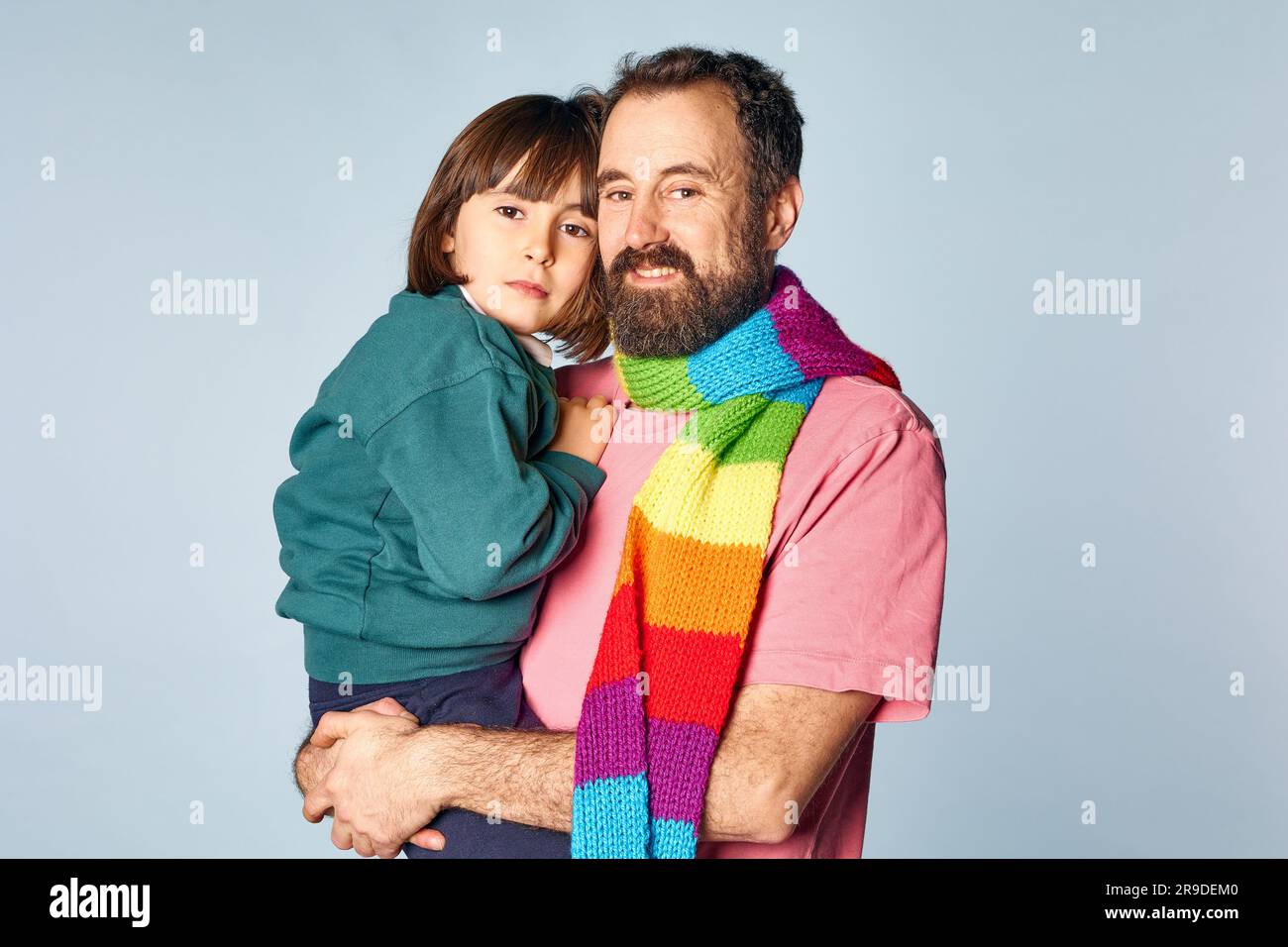 portrait of divorced lgbt father with his daughter in studio on ...