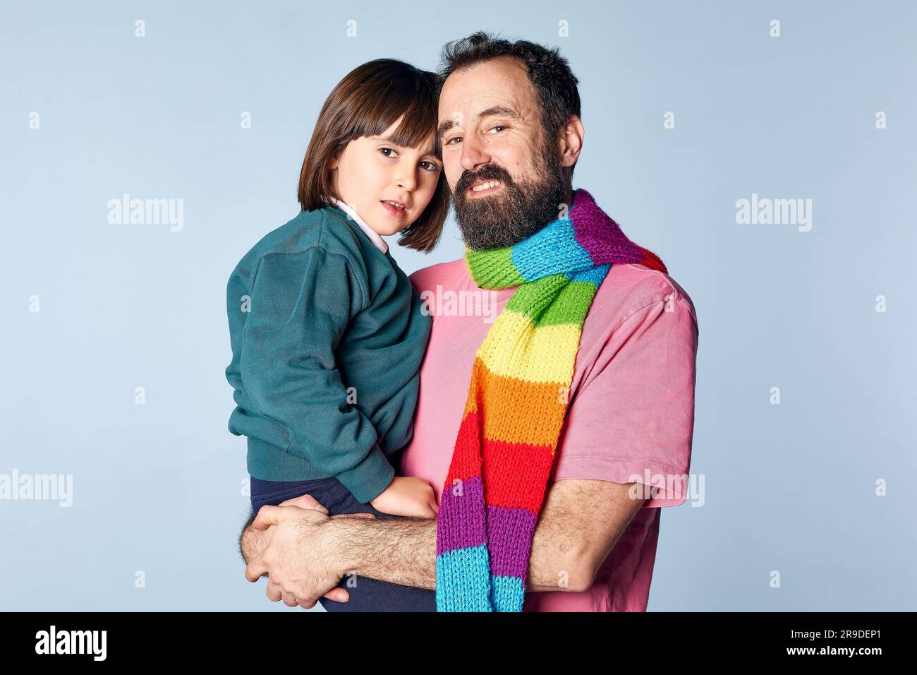 portrait of divorced lgbt father with his daughter in studio on ...