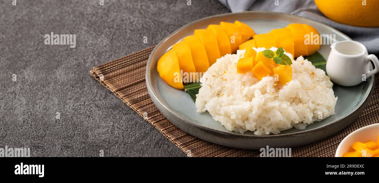 Delicious Thai mango sticky rice with cut fresh mango fruit in a plate ...