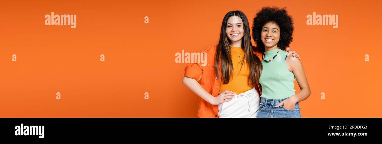 Cheerful interracial teen girlfriends with bold makeup and trendy ...