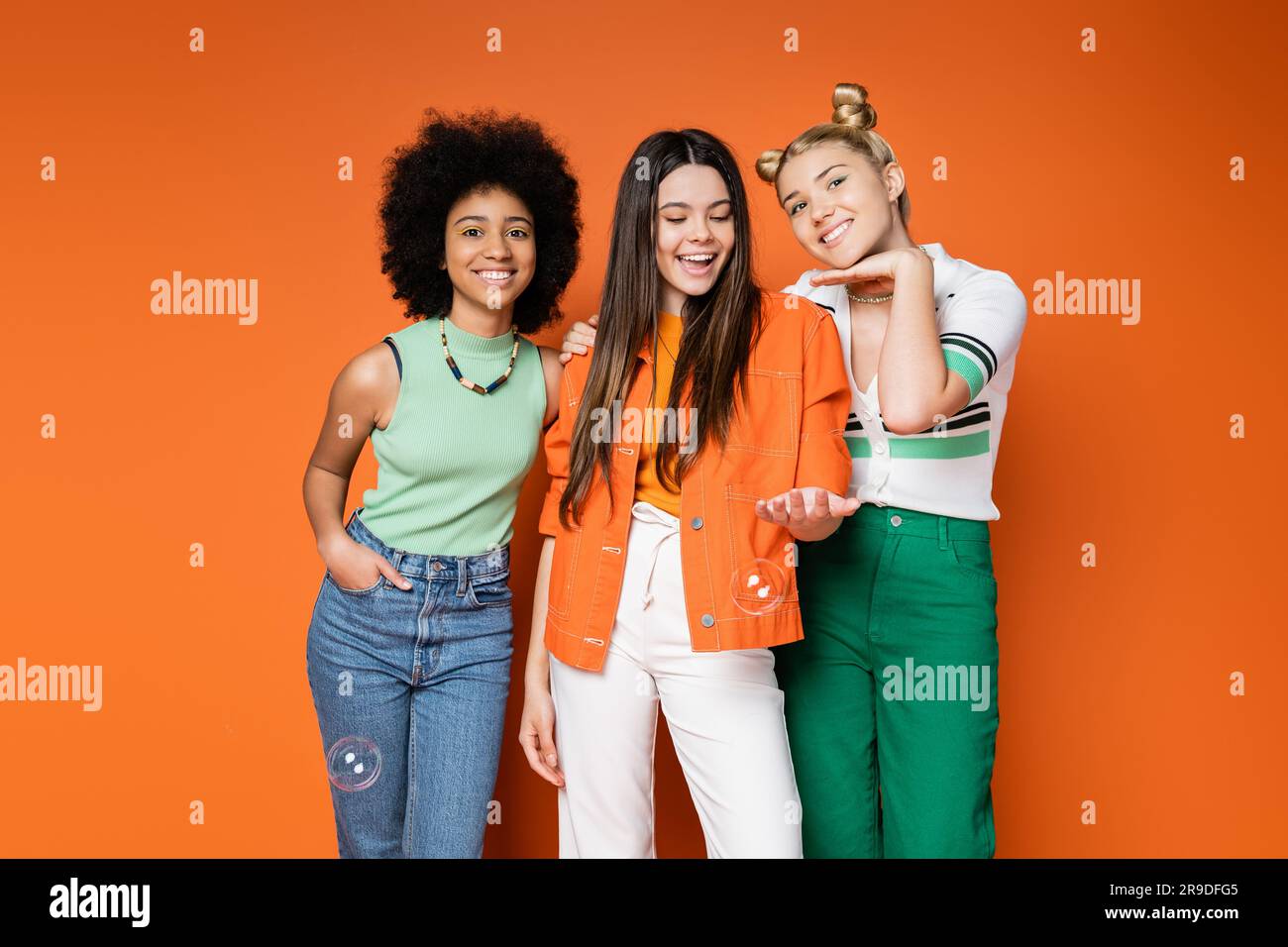 Cheerful and trendy multiethnic teenage girls with bold makeup and ...