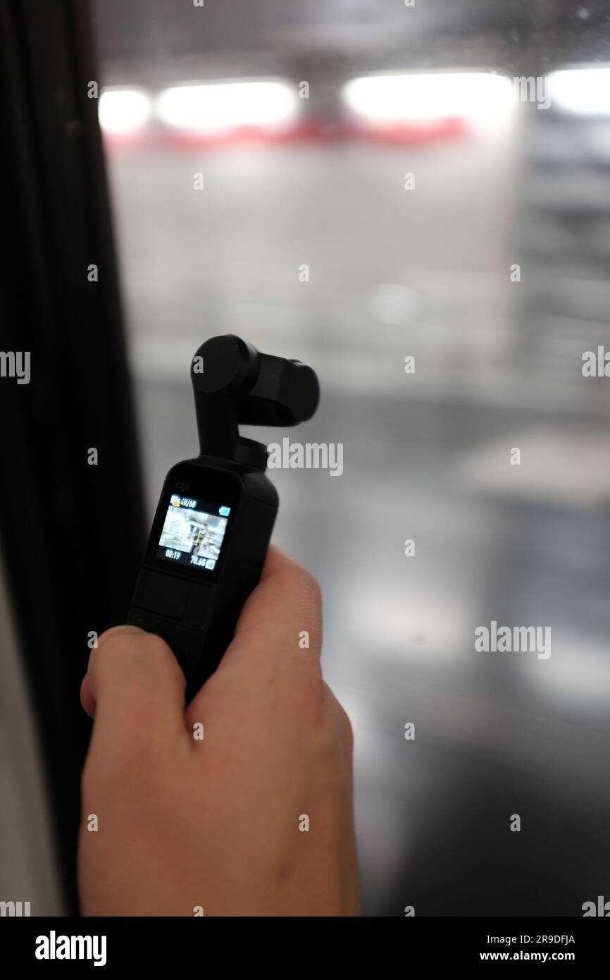 A person filming in a train using a handheld camera Stock Photo - Alamy
