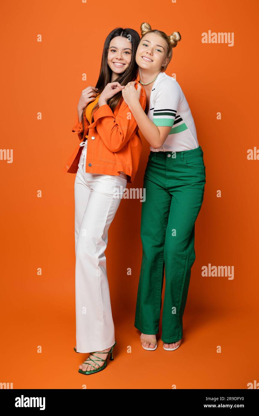 Full length of blonde trendy teenage girl in casual clothes looking at ...