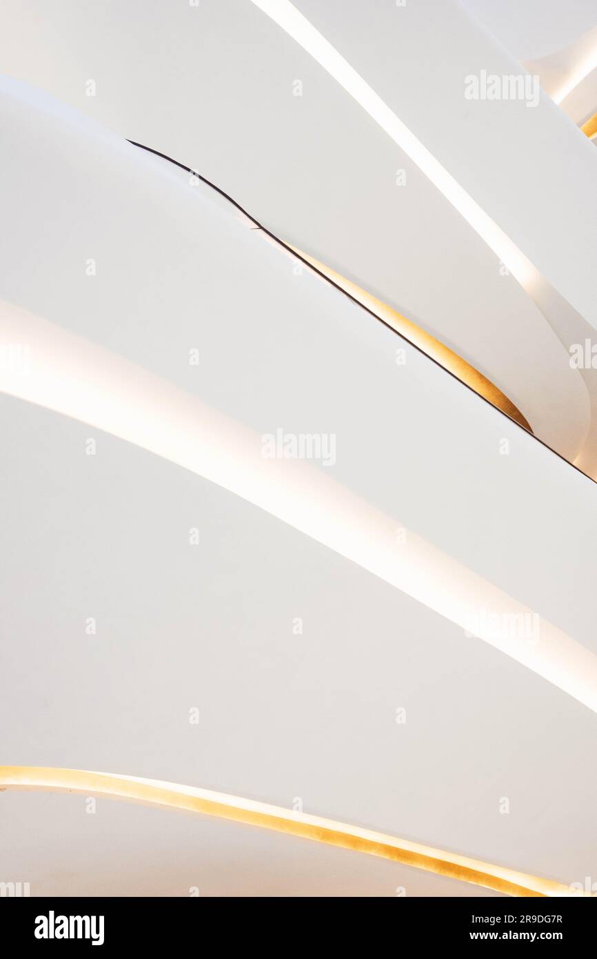 A modern architectural building illuminated by bright lights, creating ...