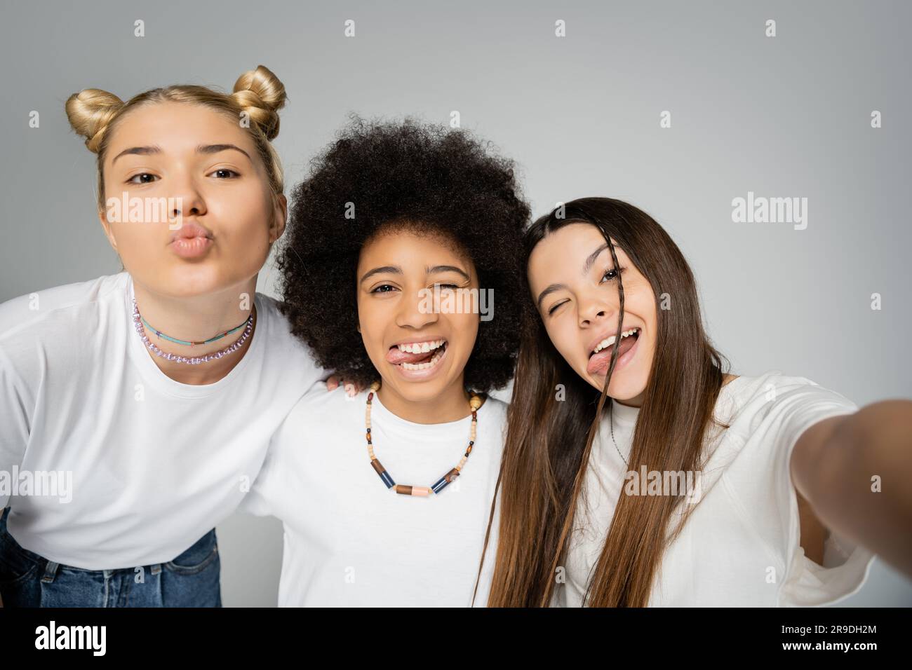 selfie, portrait of cheerful and multiethnic teenage girlfriends in ...