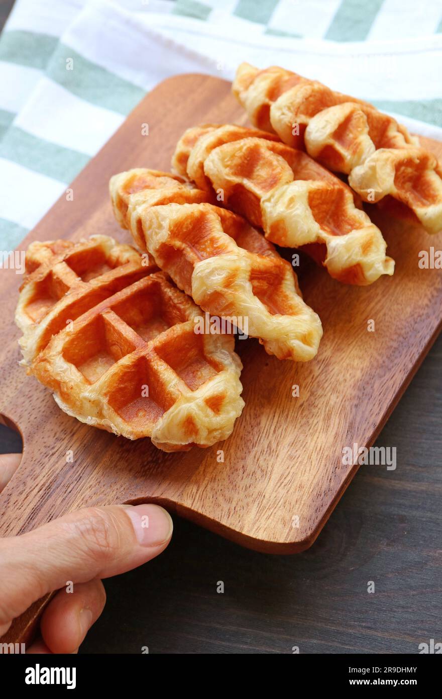 Hand Placing a Breadboard of Freshly Baked Croffles on Kitchen Table ...