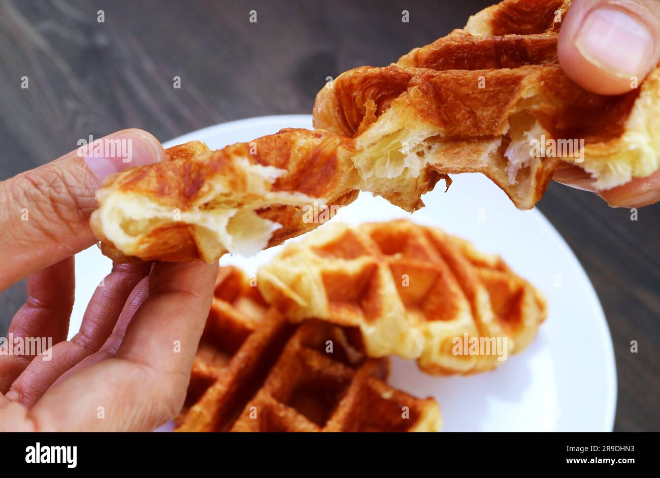 Closeup of Hand Splitting Croffle or Croissant Waffle Puff Pastry Stock ...