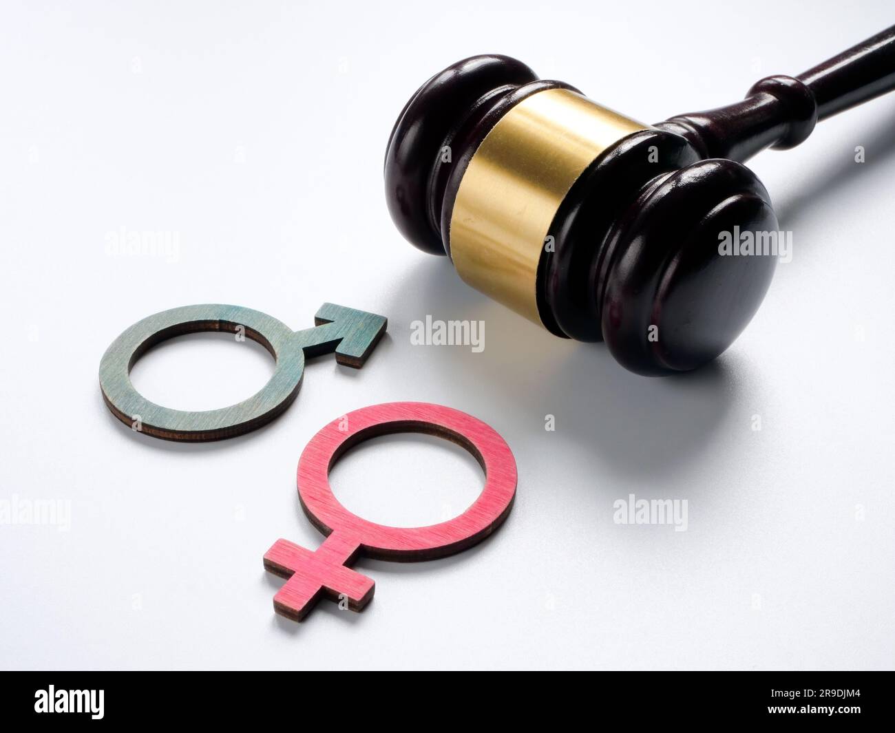 Gender discrimination concept. Male and female symbols near a gavel ...