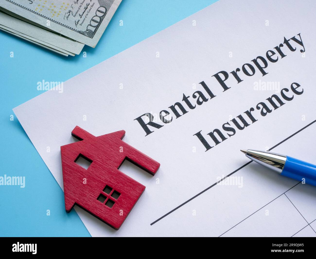Rental property insurance application and model of home Stock Photo - Alamy