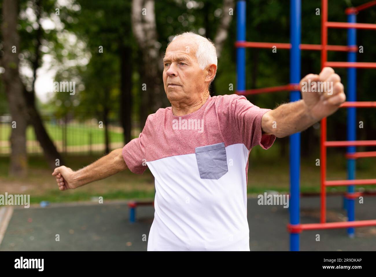 Old man warming up before training outdoors Stock Photo - Alamy