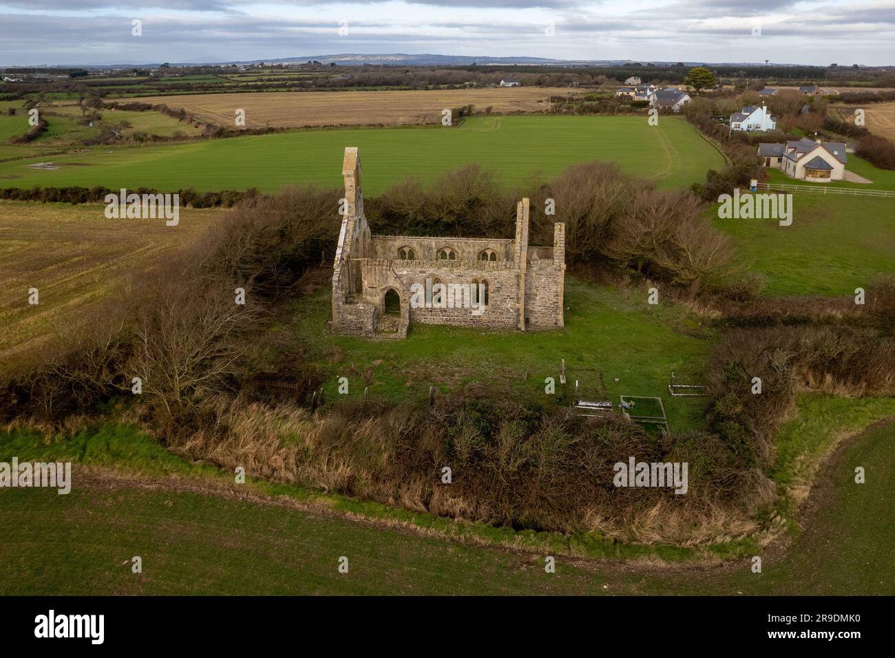 An aerial view of A rural, ruined, stone medieval Christian church ...