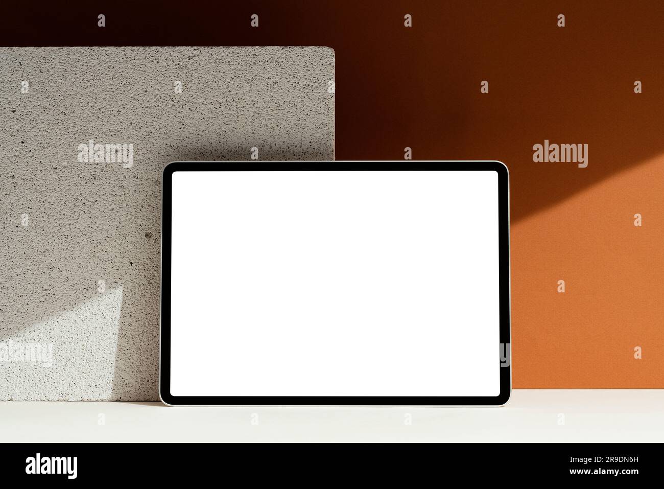 Blank screen digital tablet mockup on brown background. Sun and shade ...