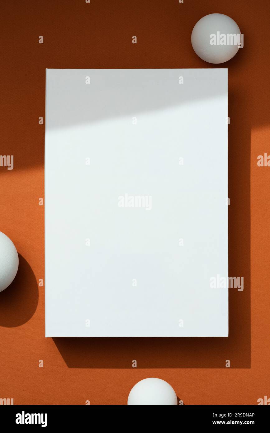 Blank white magazine cover mockup on brown background. High angled shot ...