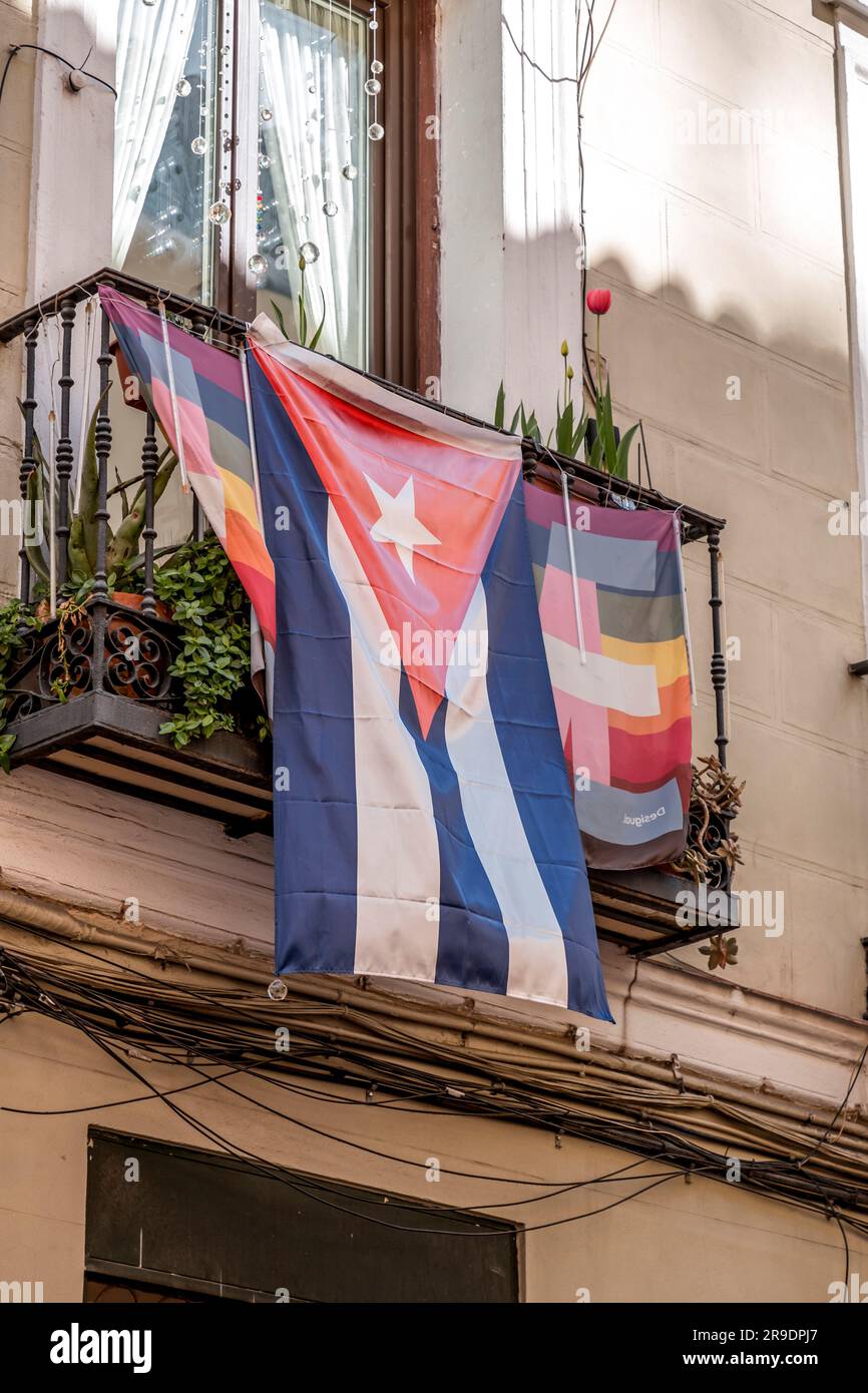 Madrid, Spain - FEB 16, 2022: Puerta Rican flag and rainbow flag hung ...