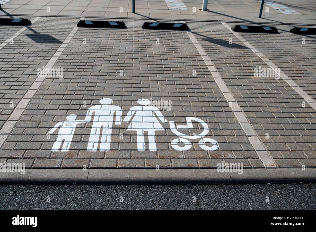 A closeup of a parents and children parking lot sign on the ground ...