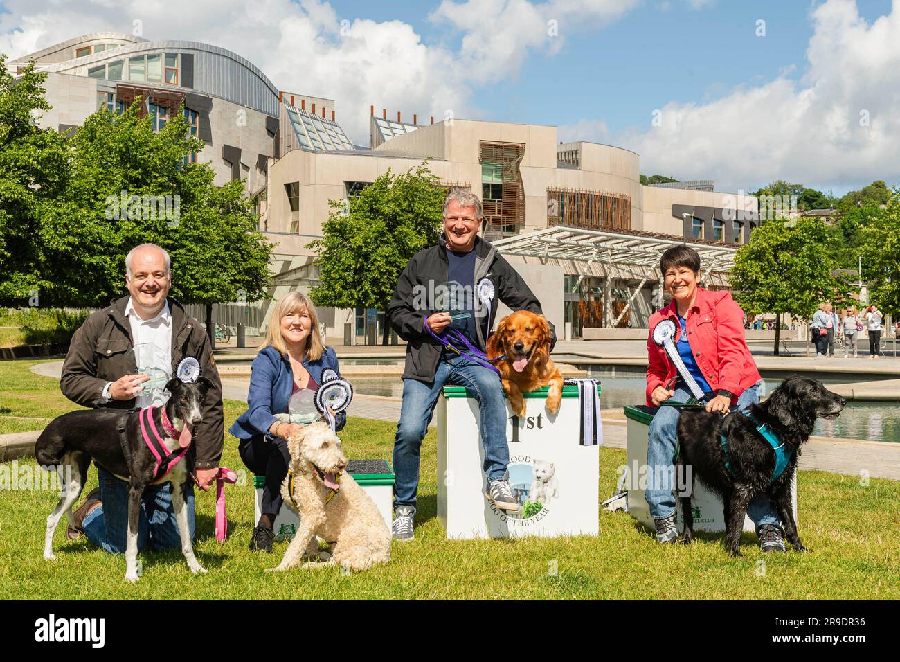 EDITORIAL USE ONLY (left to right) Joy, the Greyhound, with Mark ...