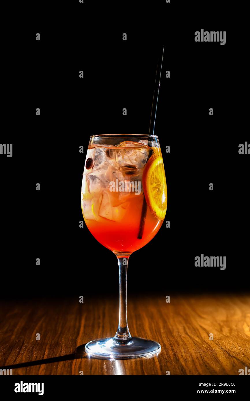 A refreshing cocktail of citrus and distilled beverages served in a tall wineglass over ice ...