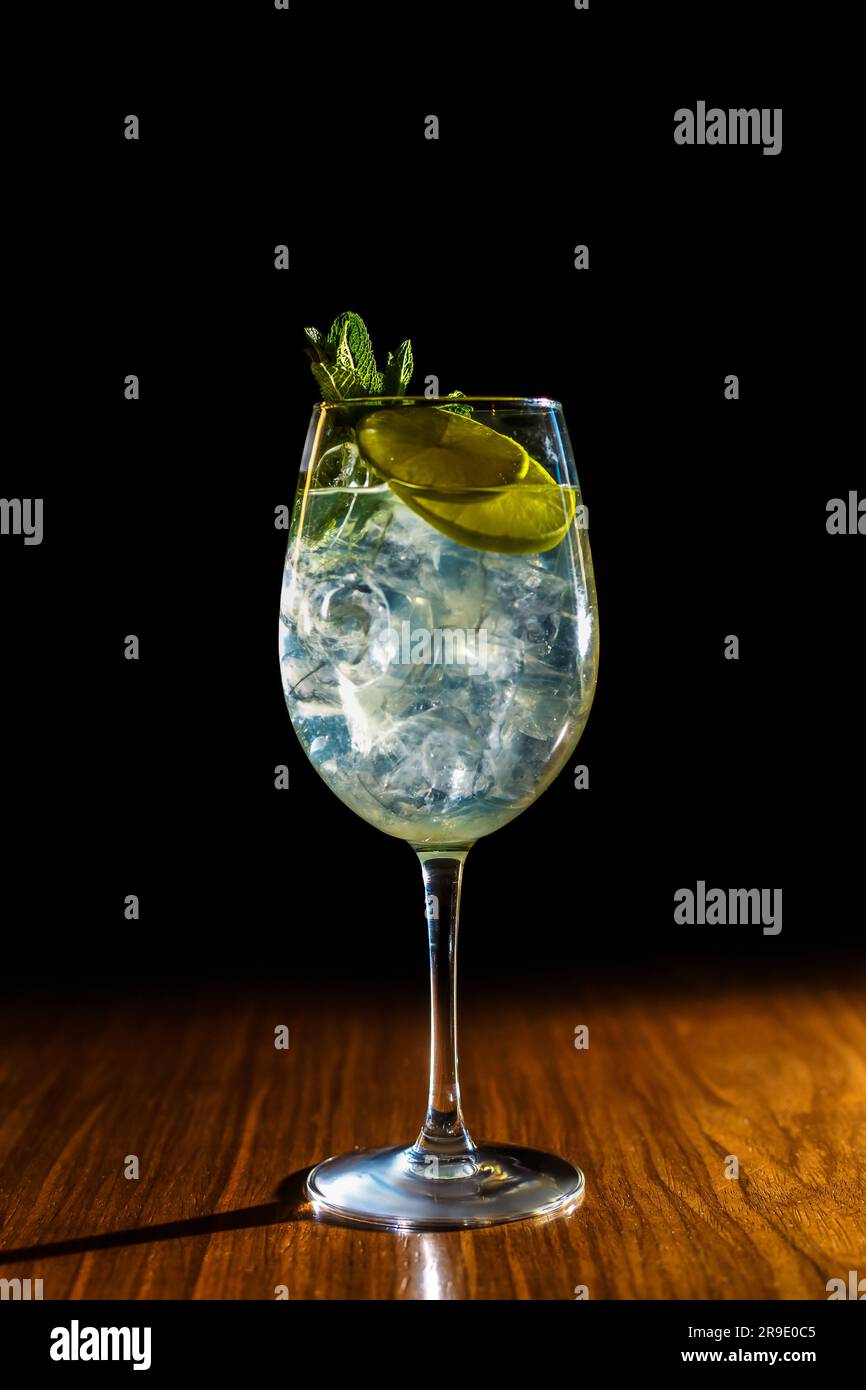 A refreshing cocktail of citrus and distilled beverages served in a tall wineglass over ice ...