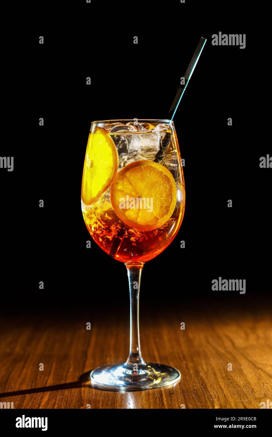 A refreshing cocktail of citrus and distilled beverages served in a tall wineglass over ice ...