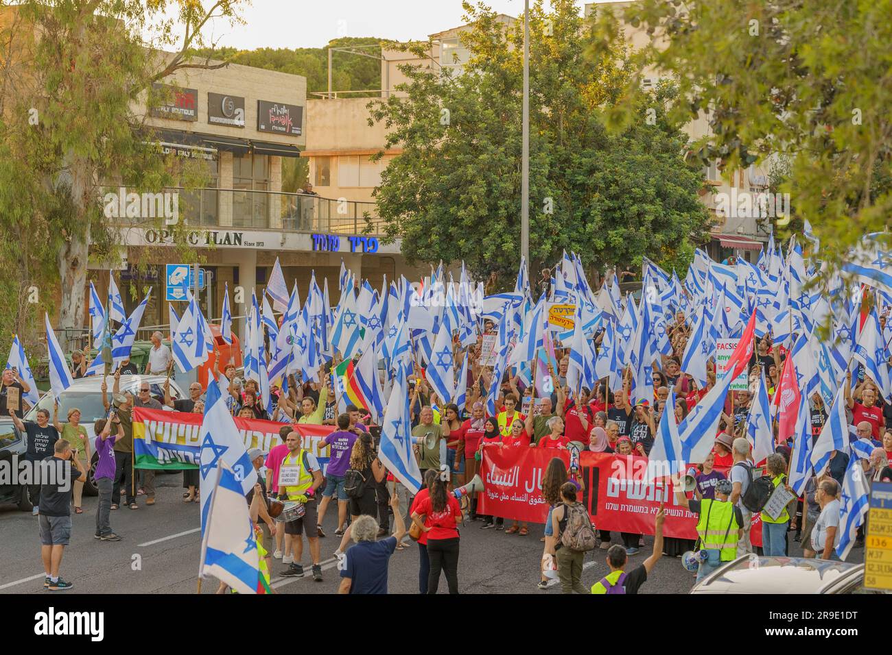 Haifa, Israel - June 24, 2023: People marching with flags and various ...