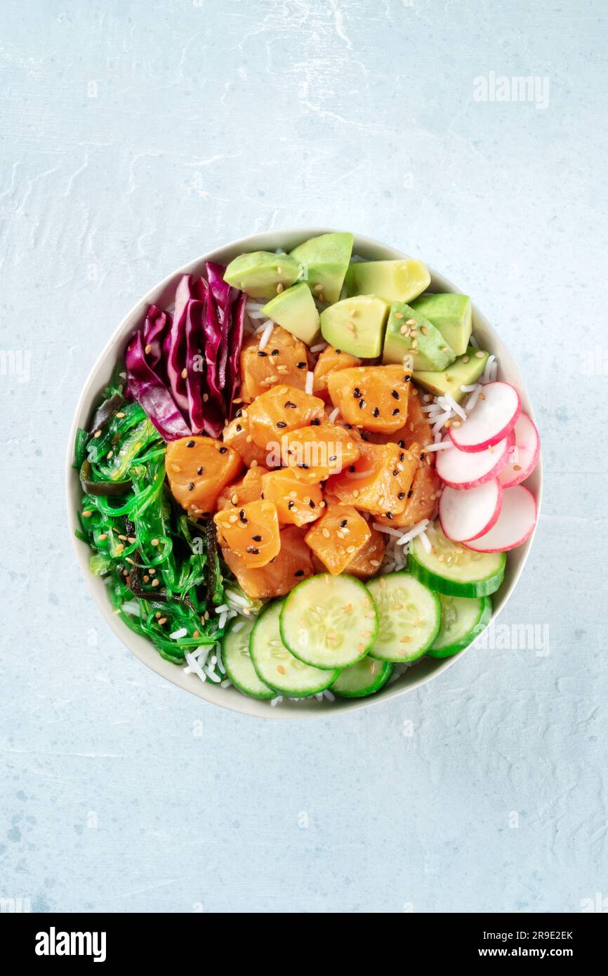 Salmon poke bowl with avocado, cucumbers, wakame, radish, and purple ...