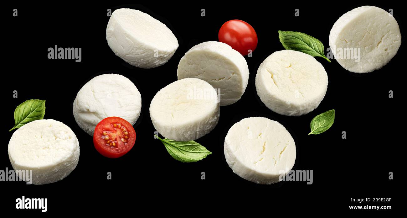 Falling mozzarella cheese slices on black background Stock Photo - Alamy