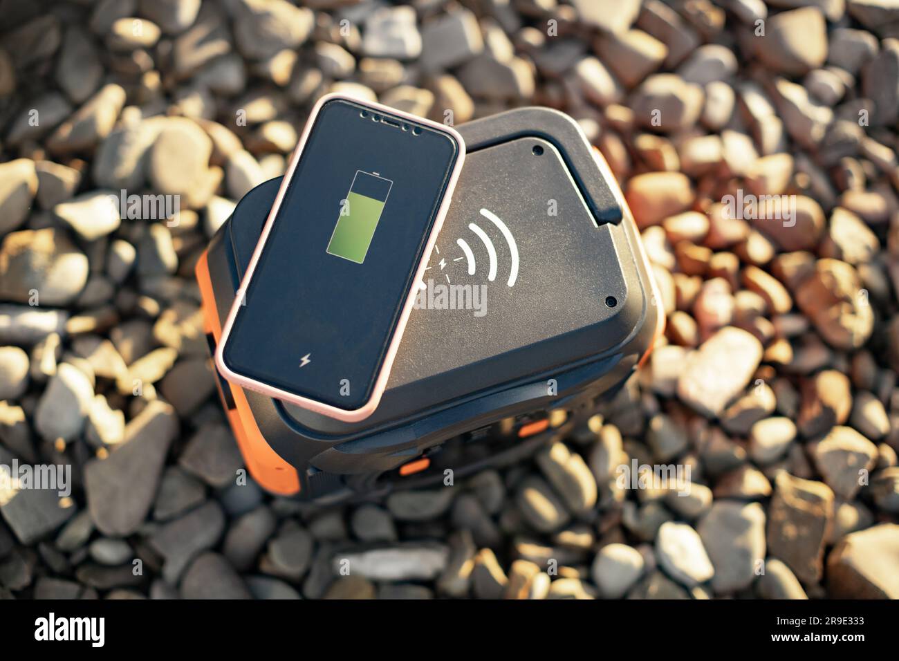 Portable digital device with green battery status on screen placed on ...