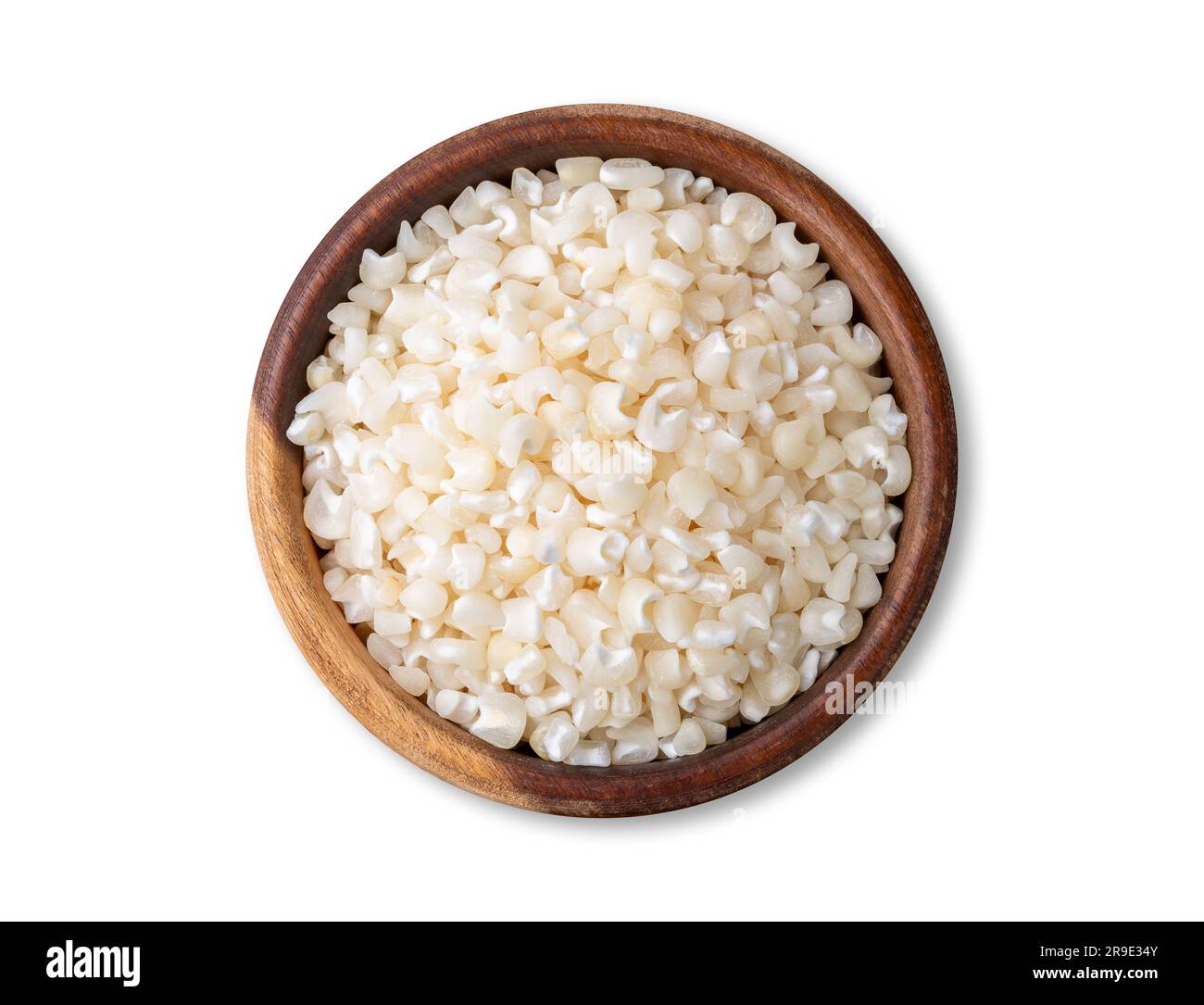 Dried canjica, hominy or white corn on a bowl isolated over white ...