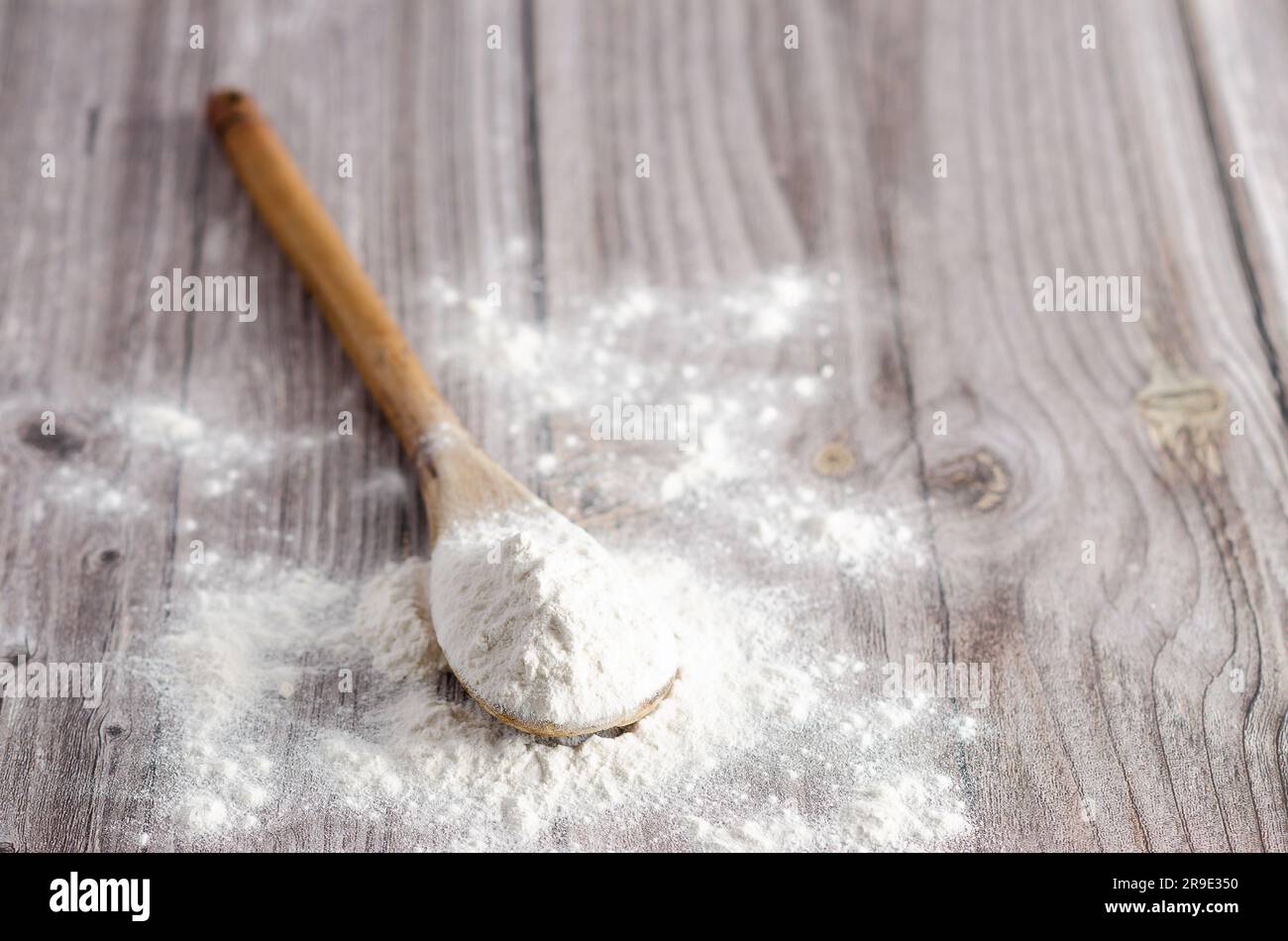 A spoonful of white flour on wooden backdrop with copy space Stock ...