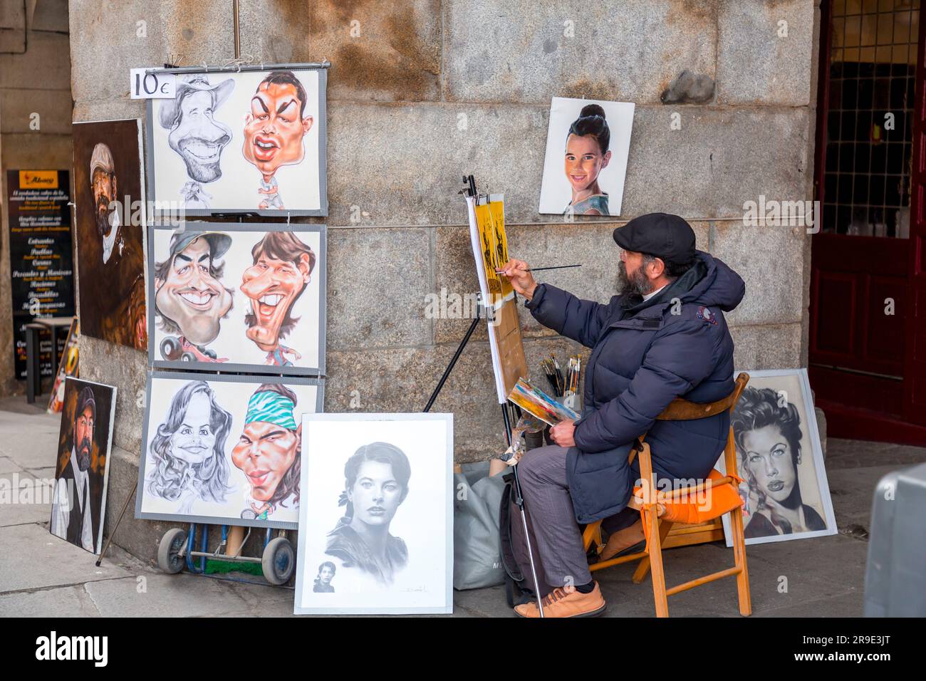 Madrid, Spain - FEB 16, 2022: Senior street artist painting and drawing ...