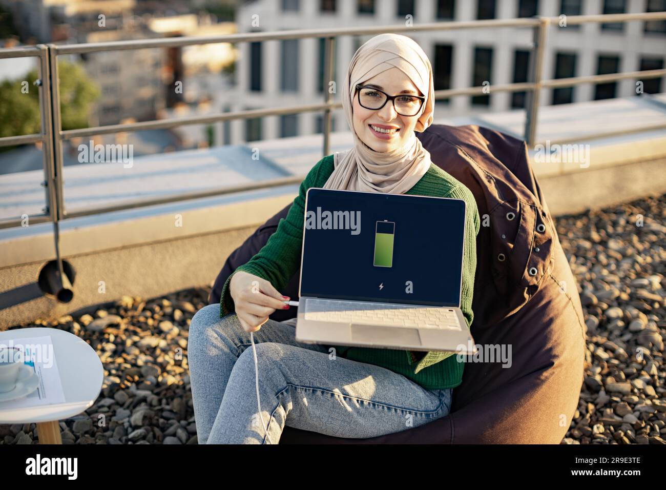 Portrait of happy muslim adult in traditional clothing holding fully ...