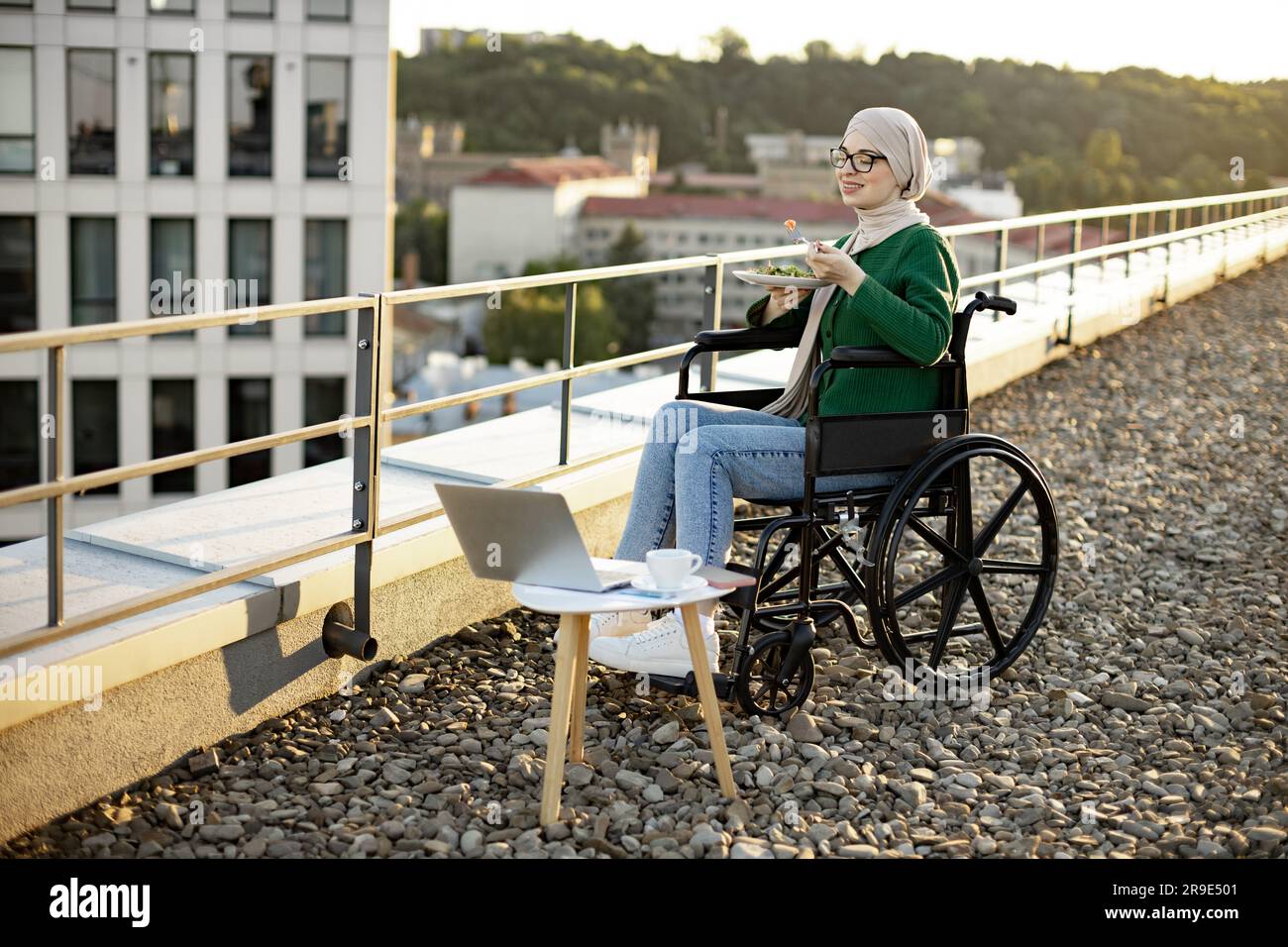 Side view of attractive muslim lady with disability eating healthy food ...