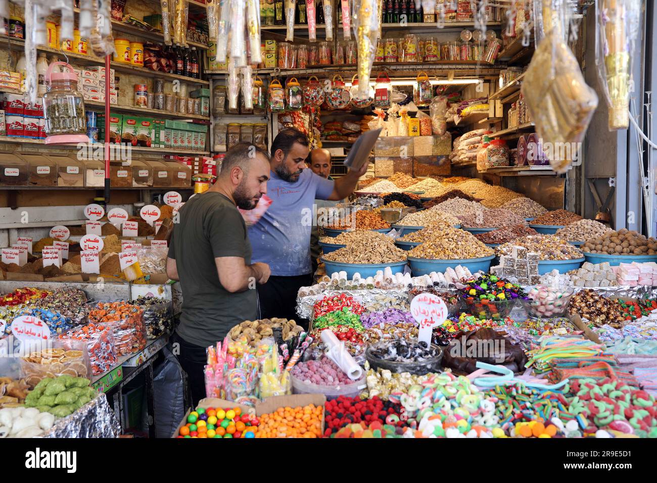 Baghdad, Iraq. 25th June, 2023. People buy sweets and nuts ahead of Eid ...