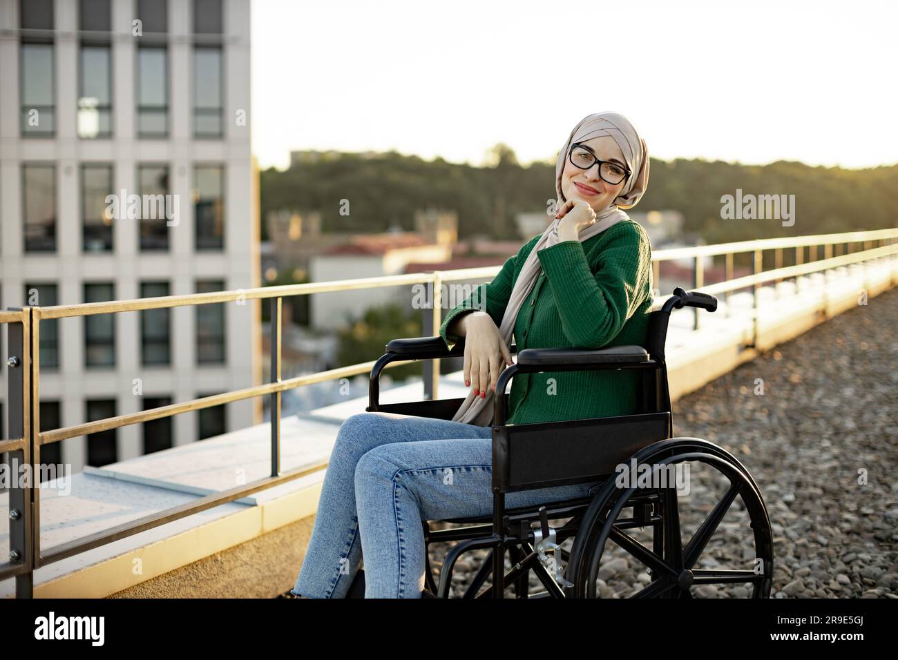 Portrait of cheerful young female with disability smiling at camera ...