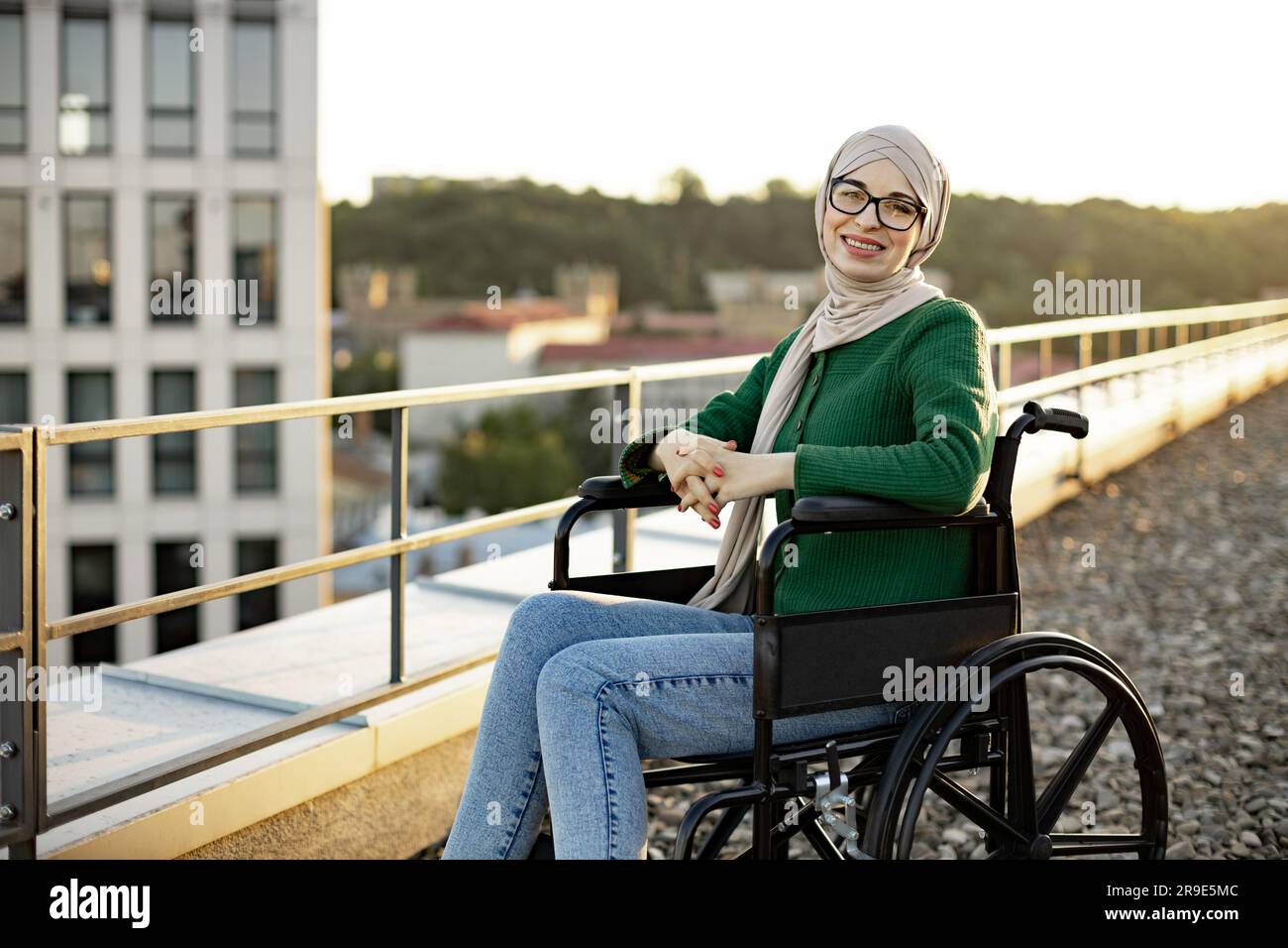 Portrait of cheerful young female with disability smiling at camera ...