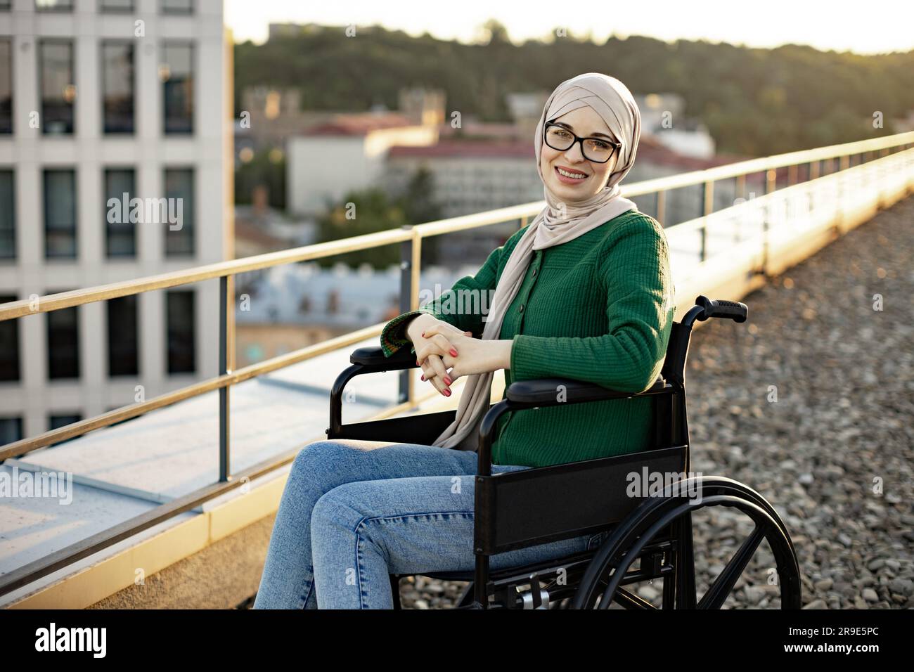 Portrait of cheerful young female with disability smiling at camera ...