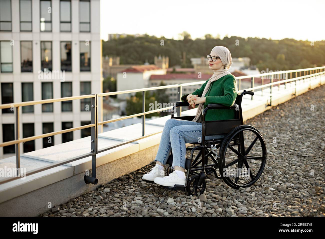 Full length view of pretty arabian lady in hijab posing in wheelchair ...