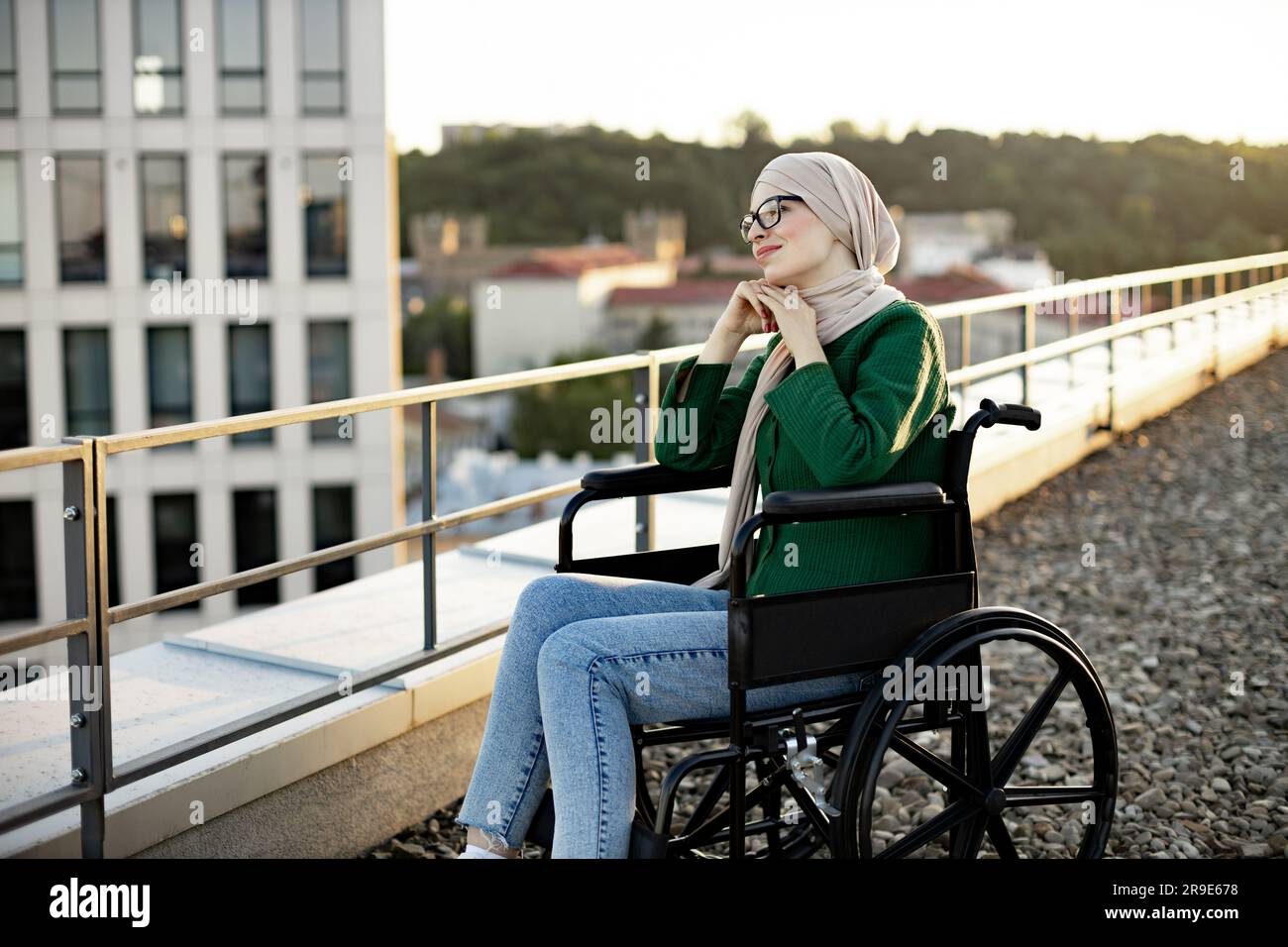 Pretty bespectacled woman with mobility issues daydreaming with hands ...