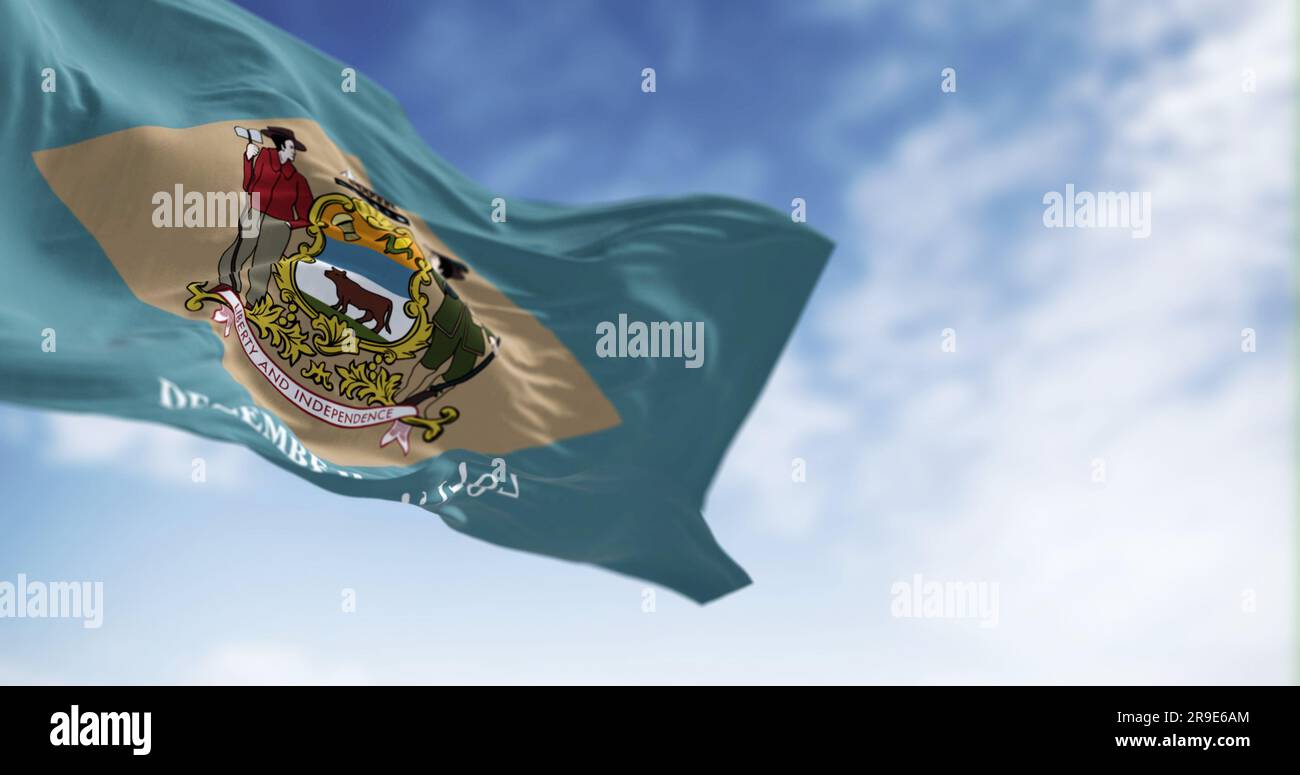 Delaware state flag waving on a clear day. Colonial blue background ...
