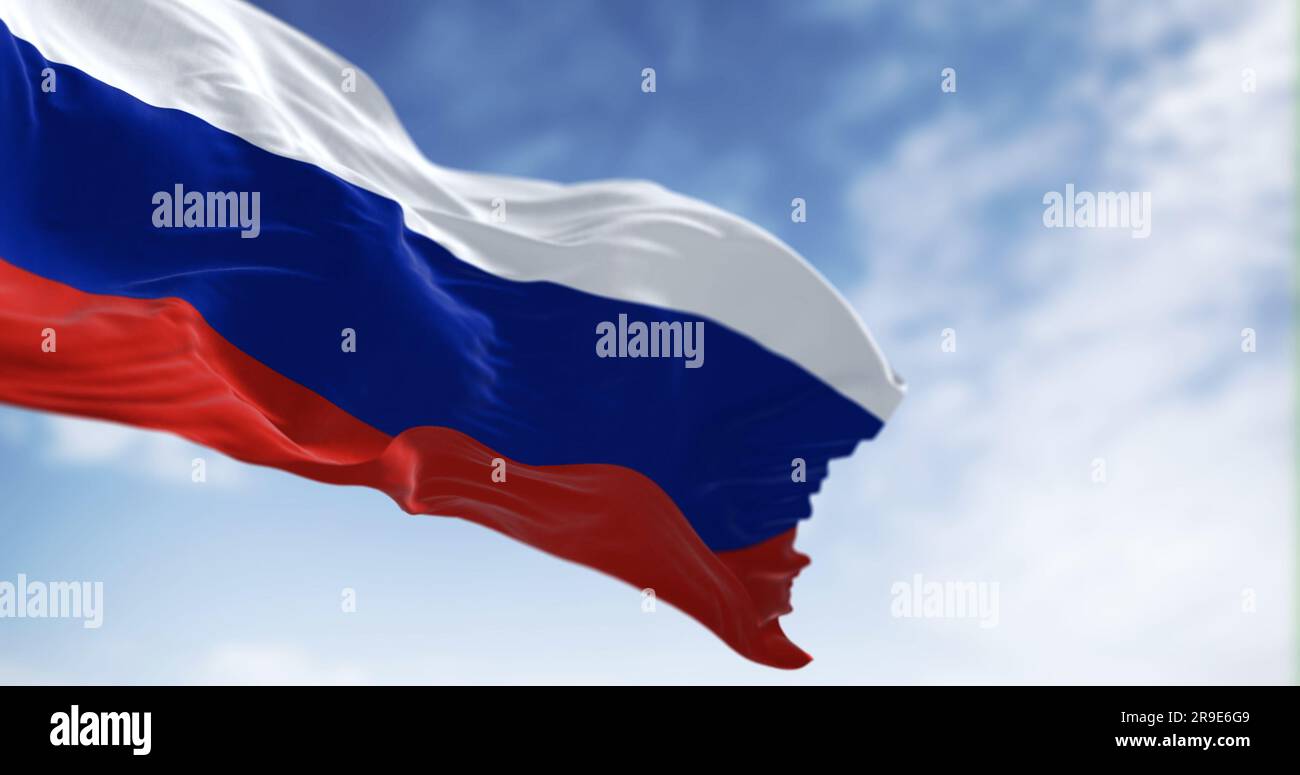 Three national flags of Russia waving in the wind on a clear day. White, blue and red horizontal ...
