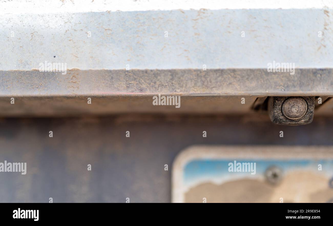 Backup camera on a vehicle obscured with dirt, mud, and dust so that ...