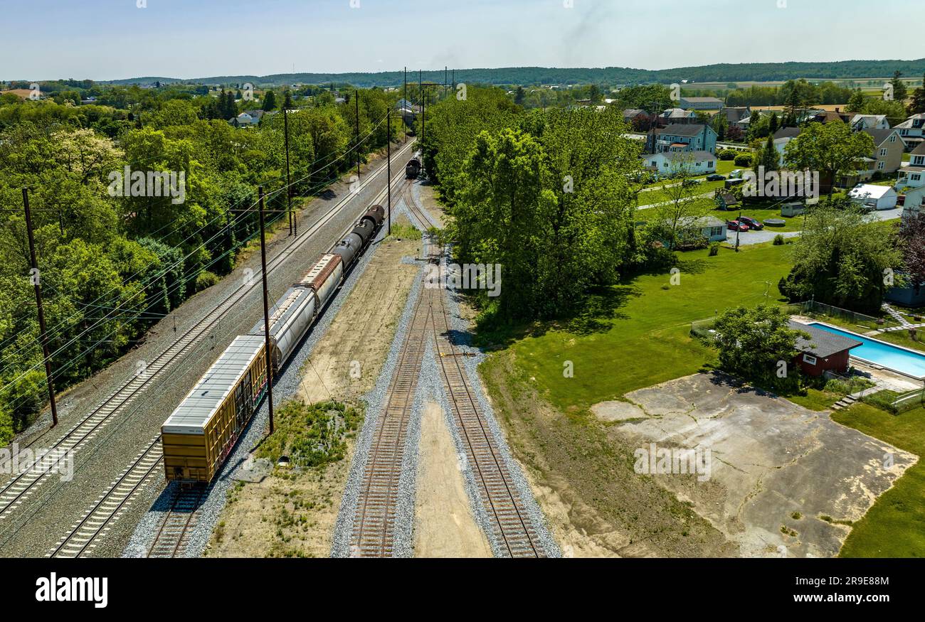 An Aerial View of a Steam Locomotive Moving Freight Cars Around in a ...